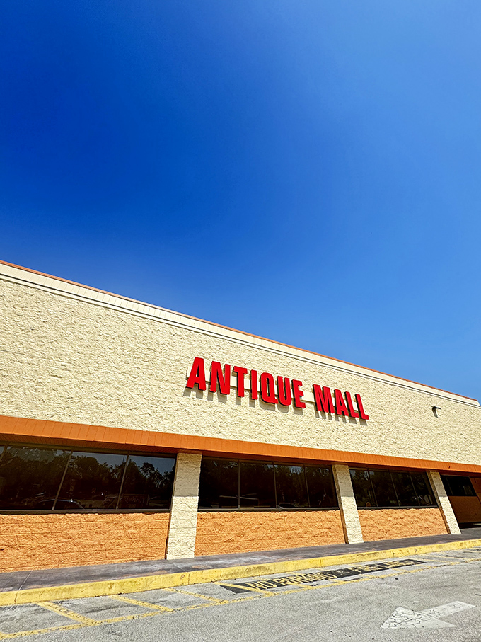Those bold red letters against cream-colored walls serve as a siren call to vintage enthusiasts and casual browsers alike. The blue Florida sky provides perfect backdrop lighting.