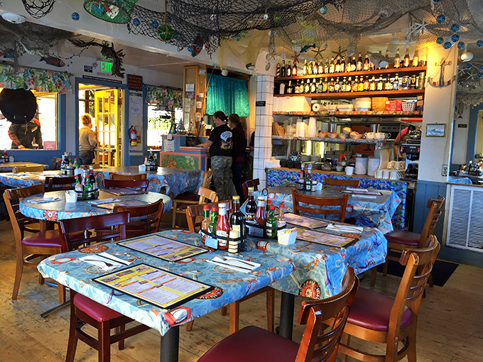 Step inside and the nautical charm hits you immediately—fishing nets overhead, blue tablecloths below, and the unmistakable buzz of happy diners everywhere.
