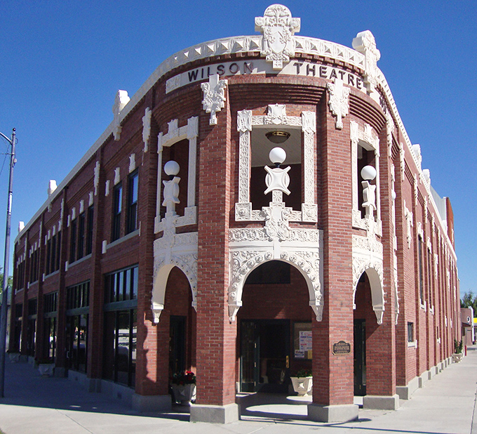 Ornate white detailing frames the Wilson Theatre's brick fa&ccedil;ade, a testament to an era when even small-town buildings were designed with architectural flair and lasting beauty.