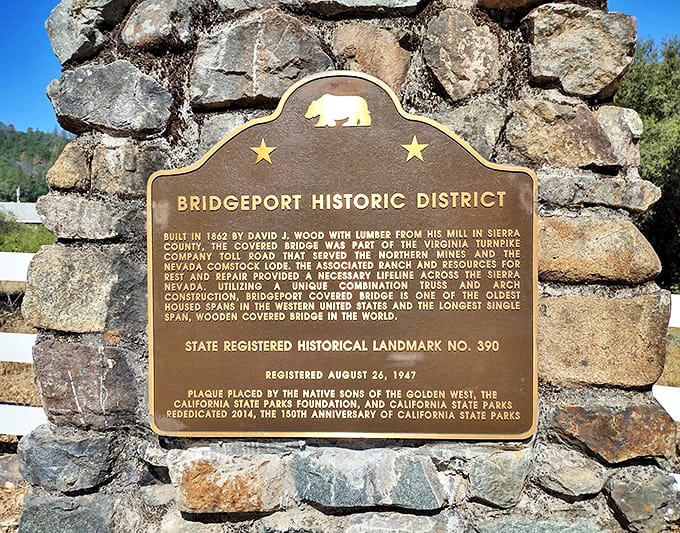 This historical marker tells the bridge's origin story - built in 1862 and still standing tall as the longest single-span wooden covered bridge in the world.