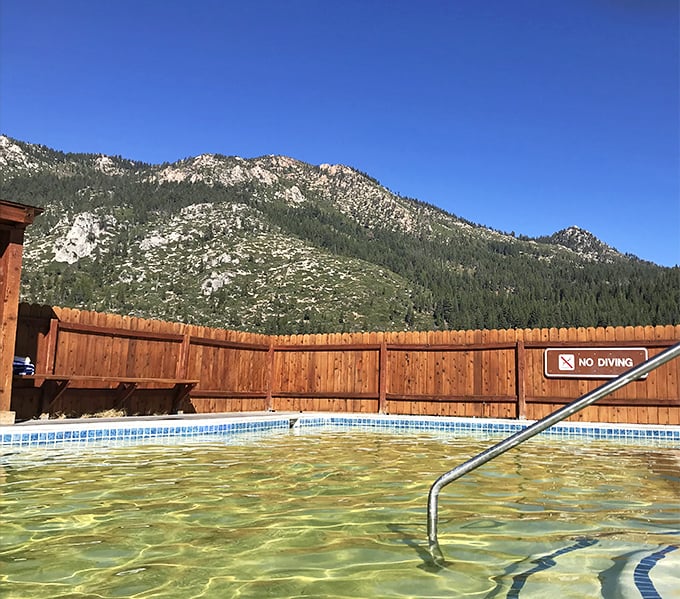 Mineral-rich waters beckon beneath wooden walls, where soakers enjoy nature's hot tub with a mountain backdrop that beats any resort view.