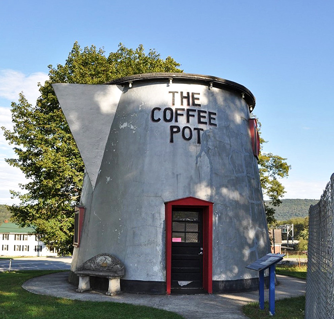 Blue skies provide the perfect backdrop for this roadside marvel. The Coffee Pot's spout juts out confidently, as if ready to pour a giant's morning brew.