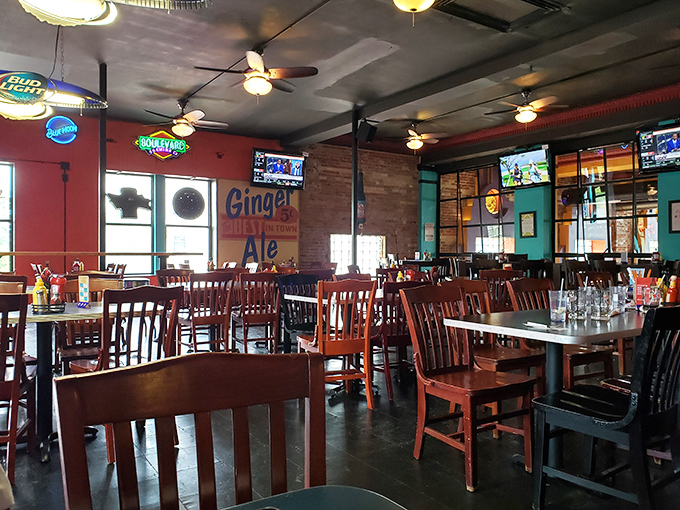 Wooden chairs, exposed brick, and colorful neon signs create the perfect backdrop for burger-induced happiness at Fitz's Delmar.