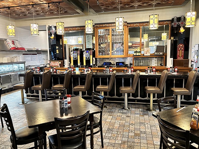 Counter seating with stylish pendant lighting offers front-row views of breakfast artistry in action. Diner heaven with a touch of class.