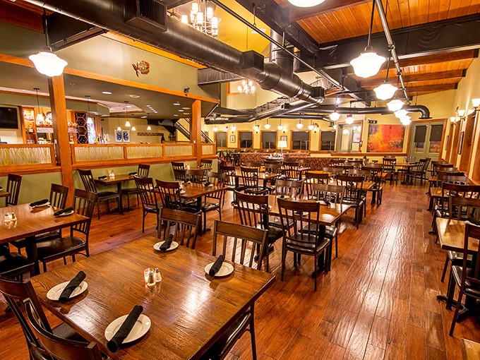 Where warm wood meets maritime magic. The dining room's exposed beams and pendant lighting create the perfect atmosphere for seafood indulgence without a hint of pretension.