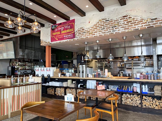 Where smoke meets style: exposed brick walls, wooden beams, and stacks of firewood create the perfect backdrop for serious barbecue business.