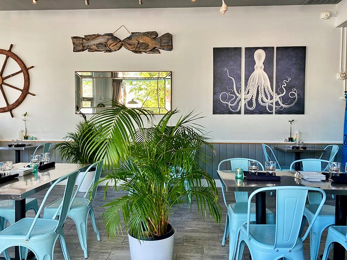 Nautical chic meets Key West cool in this airy dining room, where octopus art watches over turquoise chairs that match the ocean just blocks away.