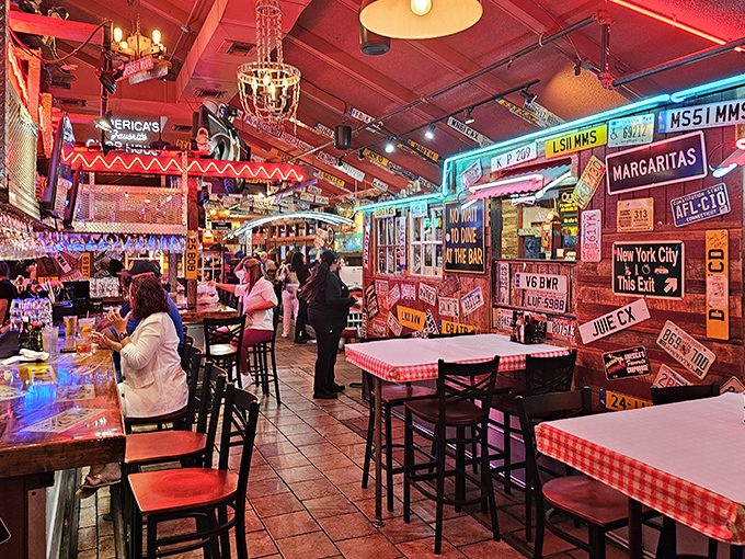 Step inside and you're greeted by a sensory overload of Americana—license plates, neon signs, and red-checkered tablecloths creating the perfect steakhouse atmosphere.