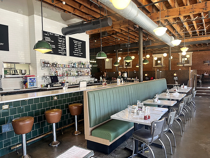 Industrial-chic meets comfort at Dilly's bar and dining area, where emerald booths invite you to settle in for the long haul.