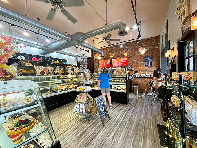 Inside, industrial chic meets old-world charm with exposed brick walls and gleaming display cases that make choosing just one treat the day's most delicious dilemma.