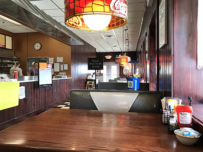 Step inside and the warm glow of vintage Coca-Cola lamps illuminates wood-paneled walls that have witnessed decades of hearty conversations and heartier meals.