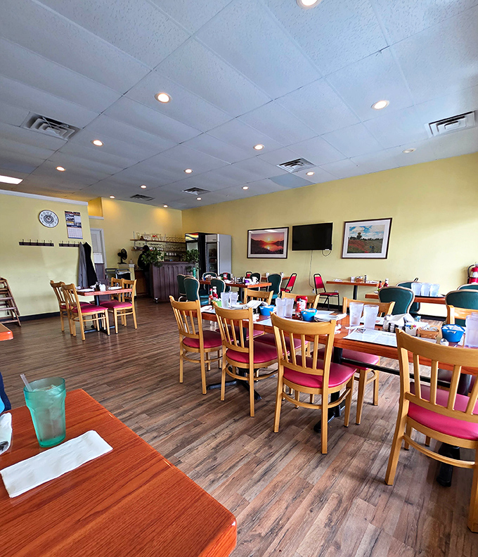 Sunshine-yellow walls and wooden chairs create that perfect "come as you are" vibe where the only dress code is an appetite.