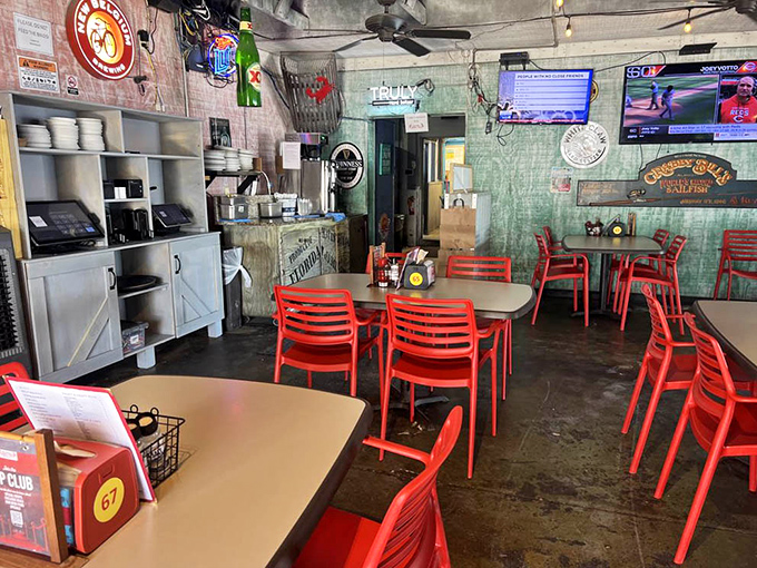 The interior's bright red chairs pop against weathered walls, creating the perfect casual backdrop for serious seafood indulgence.