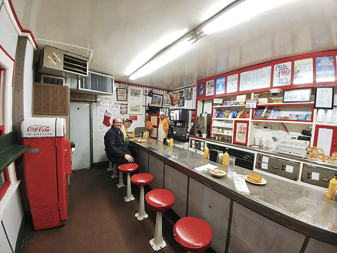 Inside, the narrow counter and red stools tell stories of countless conversations, first dates, and late-night revelations shared over legendary burgers.