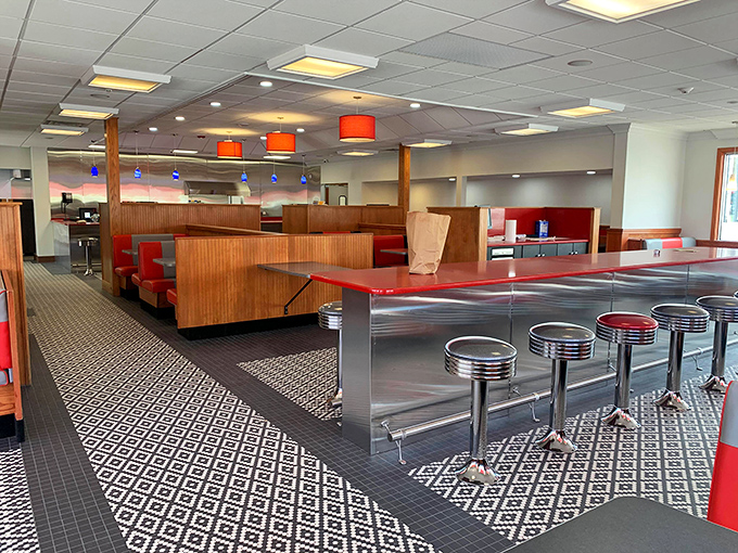 Step inside to a world where chrome gleams, red vinyl booths beckon, and the black-and-white checkered floor practically screams "classic American diner" in the most delightful way possible.