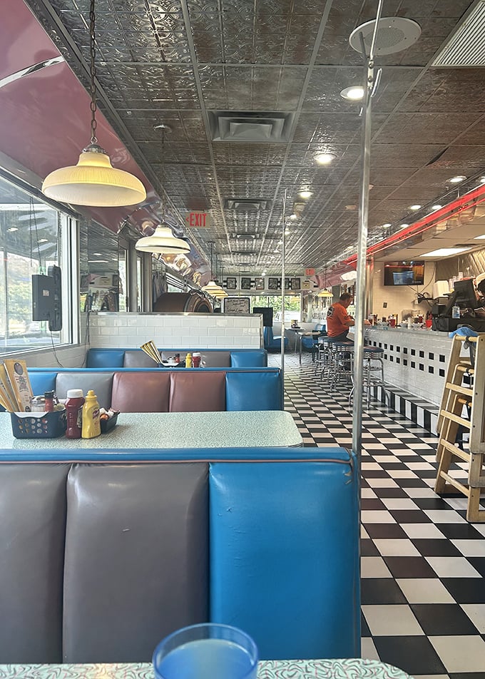 Blue vinyl booths and a checkerboard floor create the perfect backdrop for life-changing conversations over coffee and pie. This isn't decoration&mdash;it's diner DNA