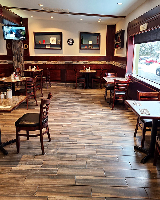 Classic diner aesthetics meet modern comfort inside Caldwell Diner, where wood-look flooring and rich dark furnishings create the perfect breakfast sanctuary.