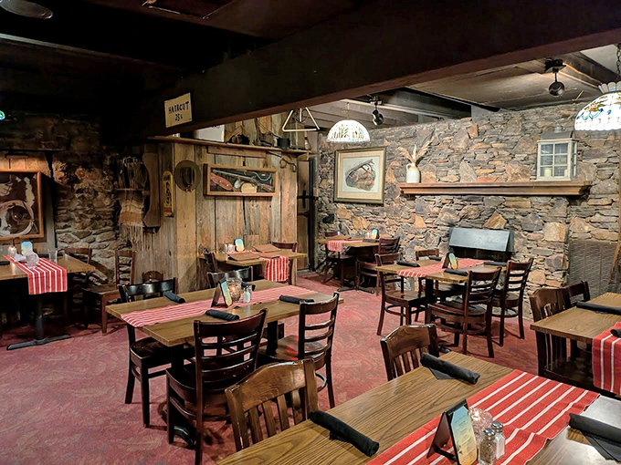 Stone walls and wooden beams create a rustic time capsule where conversations flow as freely as the wine.