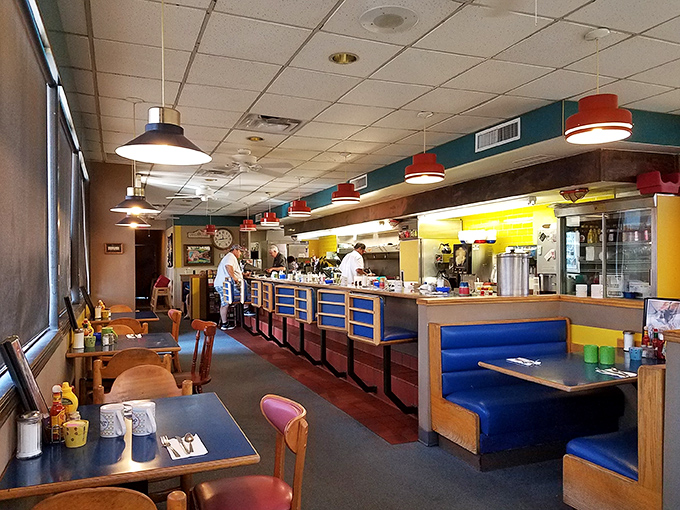 Step inside where blue booths and yellow walls create a cheerful diner atmosphere that feels like breakfast should always feel.