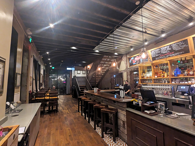 Exposed beams, warm wood, and Edison bulbs create the perfect backdrop for both morning coffee revelations and evening cocktail confessions.