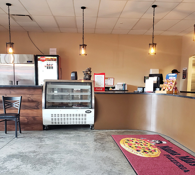 Simple pendant lighting casts a warm glow over the counter where pizza dreams come true. No pretension, just preparation for greatness.
