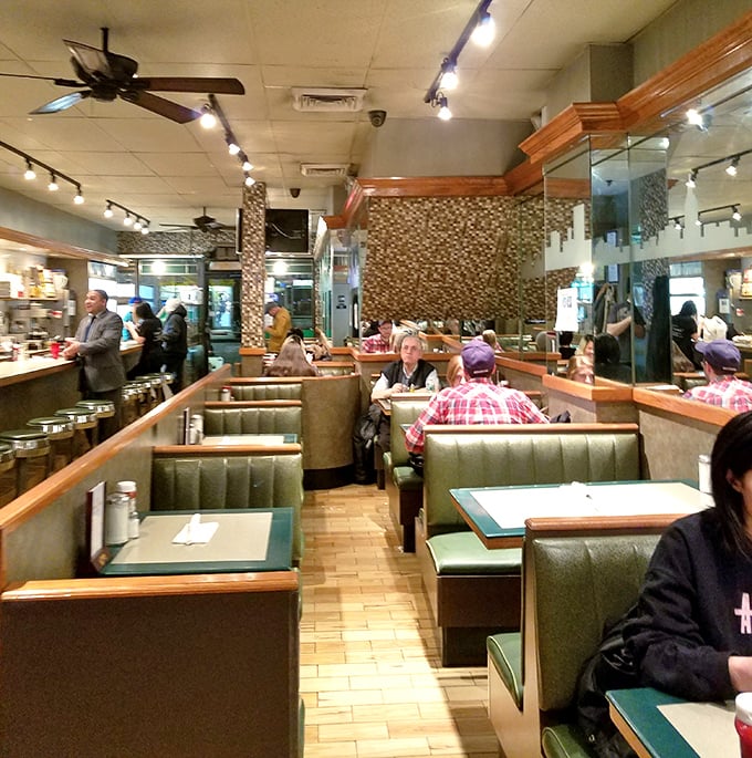 Classic diner perfection with those unmistakable green vinyl booths where countless New Yorkers have slid in for a meal. The mosaic-tiled walls have witnessed decades of conversations.
