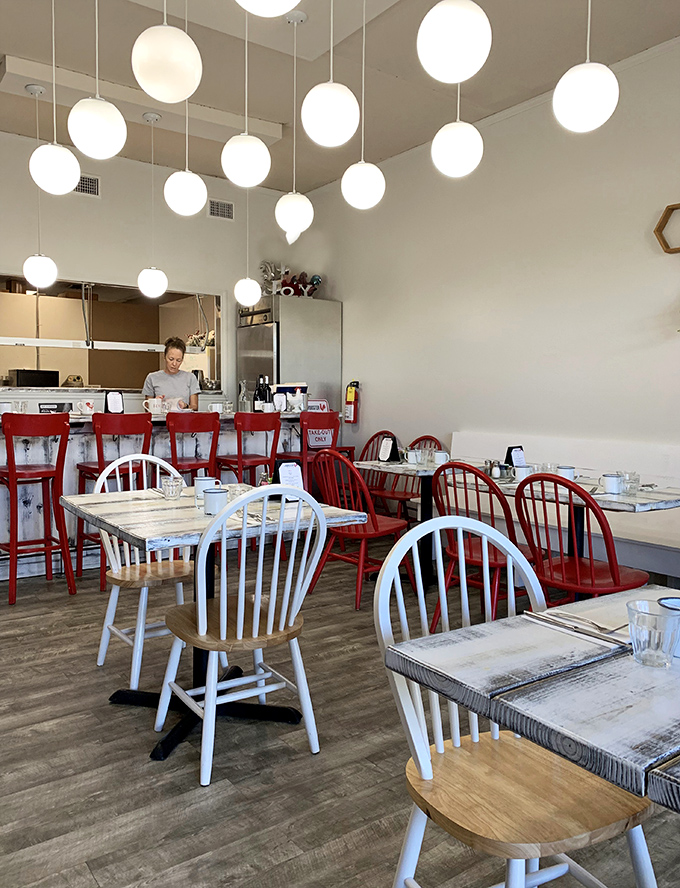 Those whimsical globe lights and mismatched chairs create the kind of cozy atmosphere where calories don't count.