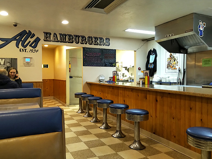 Classic diner perfection with those swivel counter stools that have witnessed decades of burger bliss and checkered floors that scream "authentic American eatery." 