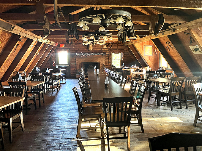 The vaulted ceiling and wagon wheel chandeliers create a cathedral-like space where barbecue is the religion and everyone's a believer.