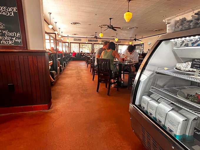 Inside, warm wood paneling and yellow pendant lights create that perfect diner atmosphere&mdash;where conversations flow as freely as the coffee refills.