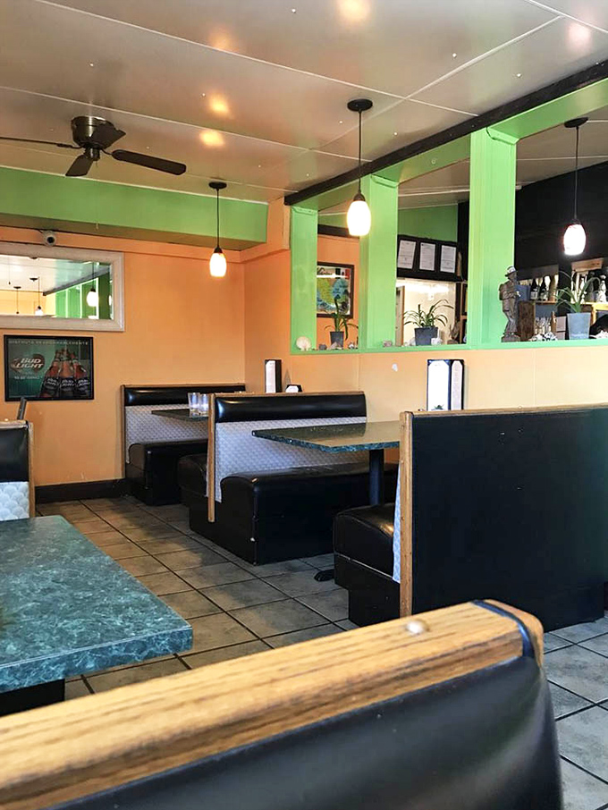 Warm orange and lime green walls create a coastal vibe that makes landlocked dining feel like a beach vacation.