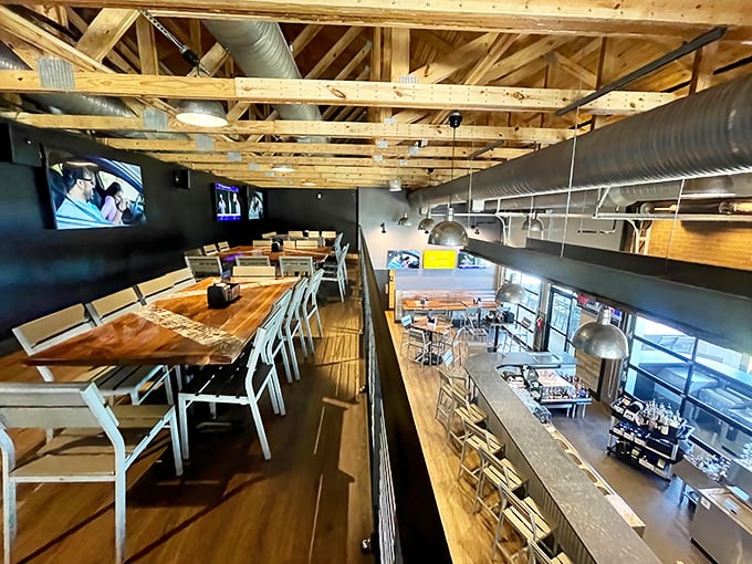 Industrial-chic meets cozy comfort with exposed wooden beams and warm lighting. The mezzanine level offers the perfect perch for people-watching while savoring your meal.
