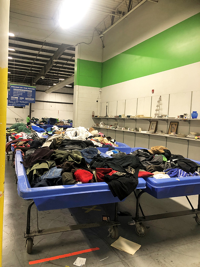 Blue bins as far as the eye can see! The outlet center entrance welcomes bargain hunters with a clear mission statement: find treasures, pay by the pound.
