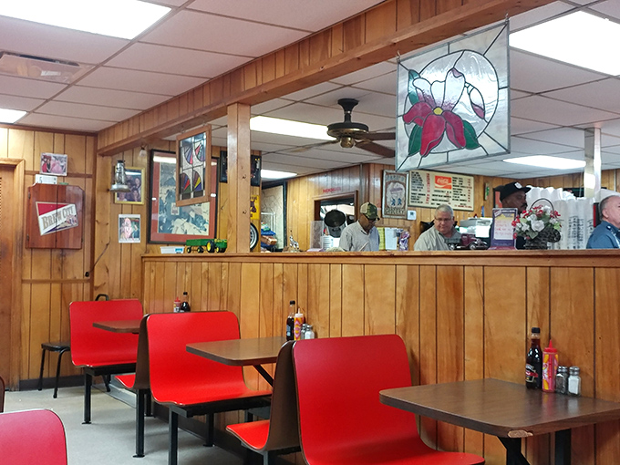 Wood-paneled walls and cherry-red seats create the perfect backdrop for burger epiphanies, while that stained glass light fixture adds unexpected artistry to this temple of comfort food.