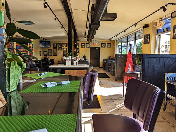 Green placemats brighten the cozy interior where purple chairs invite you to settle in for a meal worth lingering over.