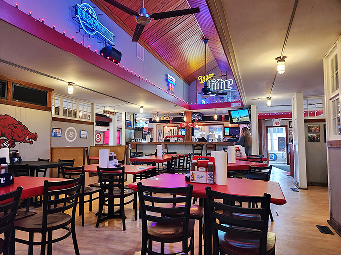 Inside, Razorback pride meets barbecue paradise with wooden ceilings, neon beer signs, and an atmosphere that feels like your favorite uncle's living room—if your uncle was a pit master.
