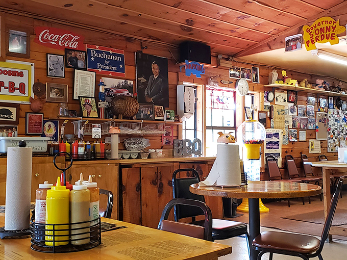 Wood-paneled walls covered in memorabilia tell stories of decades past, while condiment caddies stand ready for the serious business of barbecue enhancement.