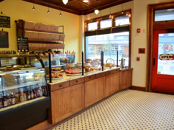 Step inside and witness the holy trinity of bakery bliss: warm wooden counters, classic black and white tiles, and display cases that belong in the Louvre of carbs.