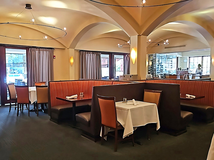 Curved ceilings and warm lighting create an intimate atmosphere where every table feels like the best seat in the house.