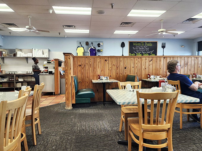 Wooden wainscoting and checkered tablecloths create that perfect "come as you are" vibe where breakfast dreams become delicious reality.