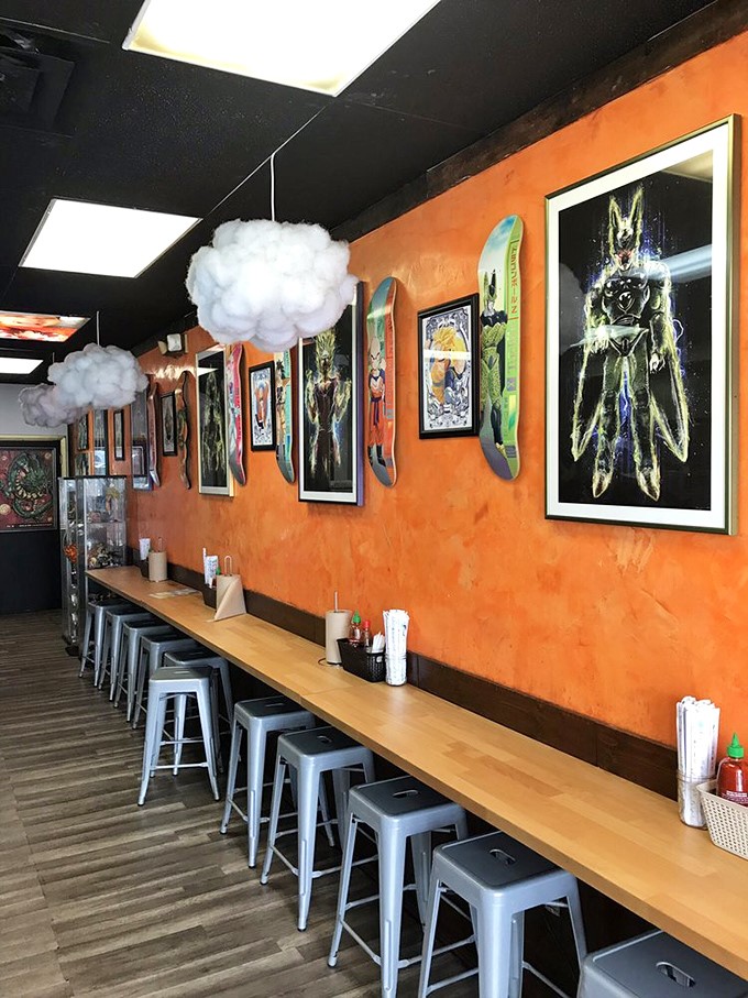 Orange walls meet nimbus cloud lamps in this Dragon Ball paradise. The counter seating invites you to power up with noodles while surrounded by anime art.