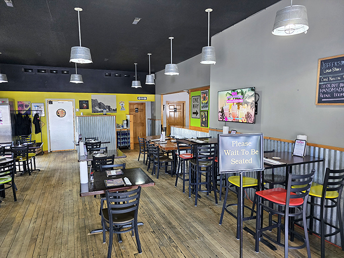 Wooden floors that have witnessed countless BBQ pilgrimages, corrugated metal wainscoting, and those cheerful yellow walls create the perfect backdrop for serious meat appreciation.