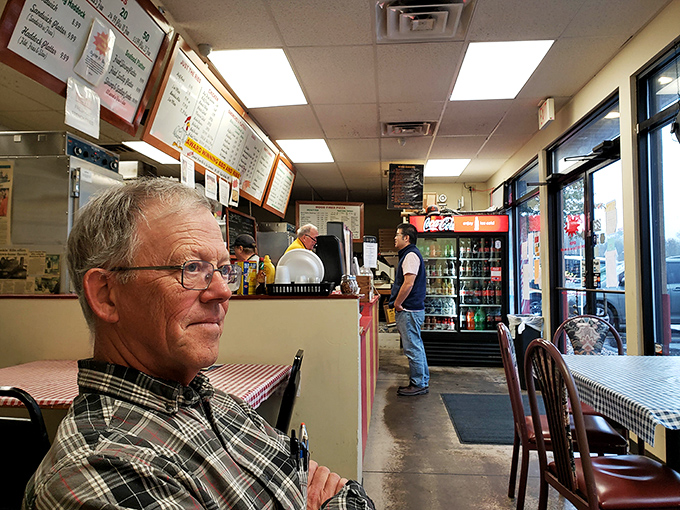 The interior view reveals the heart of BBQ operations&mdash;where hungry patrons line up for smoky treasures while menus tempt from above.