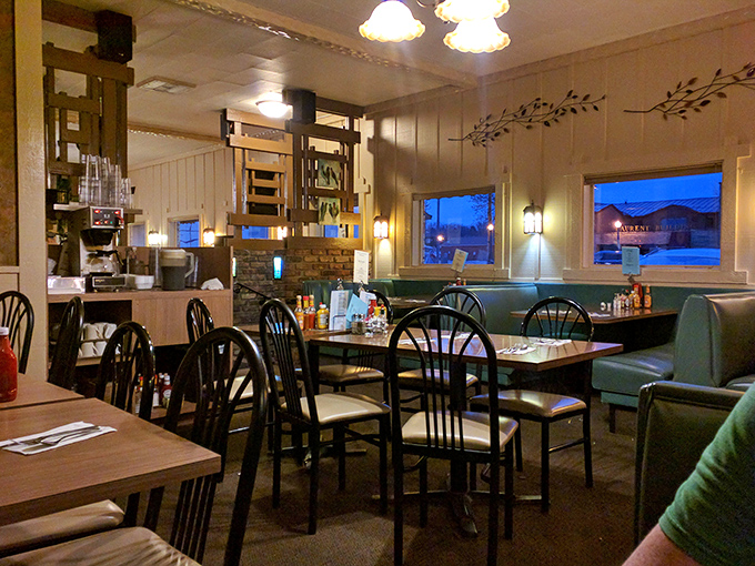 Step inside and time travel to a simpler era where teal vinyl booths and warm wood paneling create the perfect backdrop for morning conversations and coffee refills.