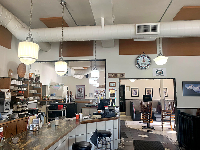 Pendant lights cast a warm glow over the counter where breakfast magic happens at Diamond Jim's Grill.