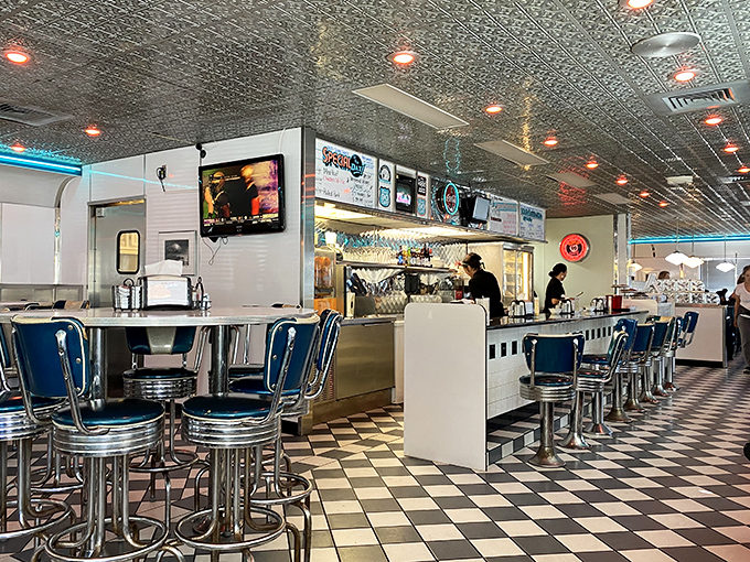Blue vinyl stools and a checkered floor&mdash;this isn't interior design, it's a declaration that some traditions are worth preserving.