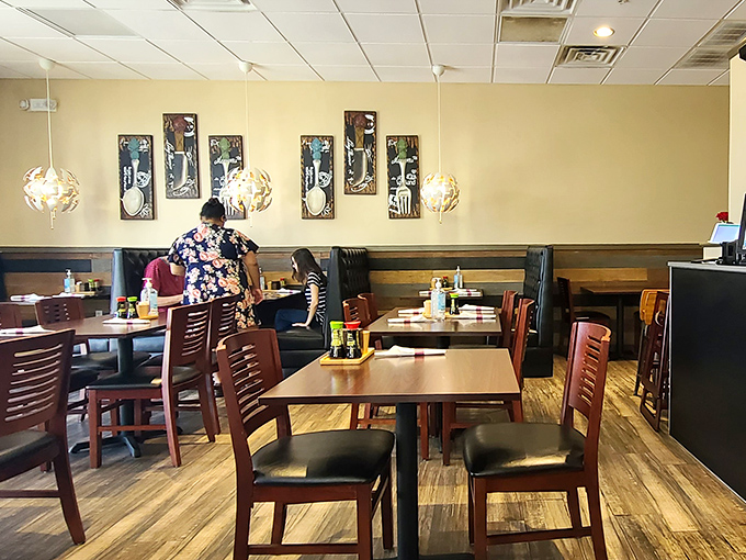 Simple wooden tables and subtle Thai artwork create a comfortable, unpretentious atmosphere where the food takes center stage.