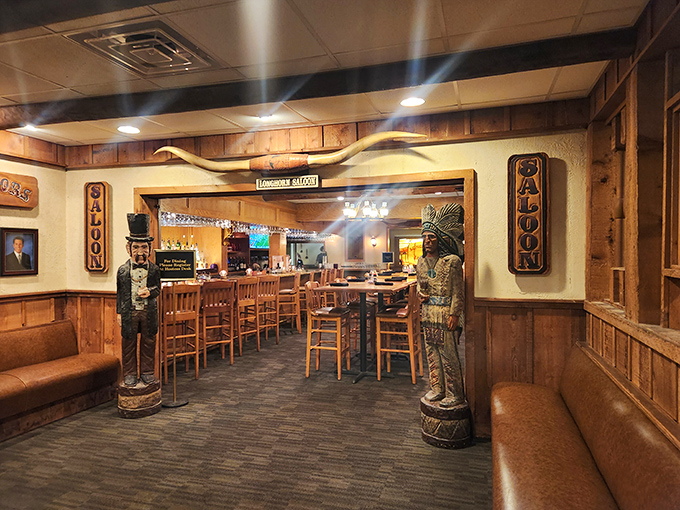 The Long Horn Saloon entrance, flanked by wooden carvings, sets the rustic tone for your evening of indulgence at this Panama City Beach institution.