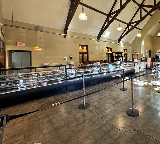 High ceilings, exposed beams, and gleaming display cases create a cathedral-like atmosphere where pastry pilgrims come to worship.