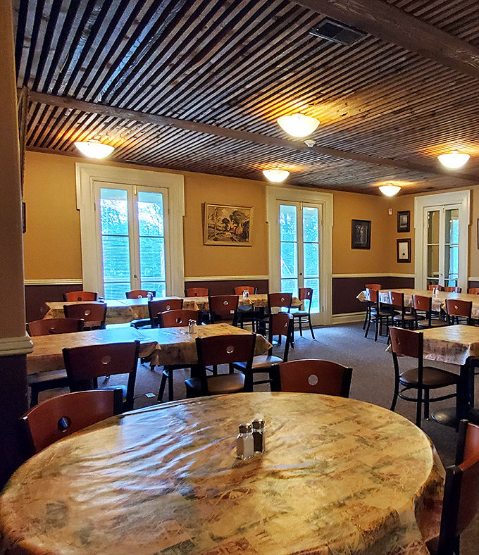 Where rustic meets refined. The dining room's corrugated metal ceiling and warm wood tables create the perfect backdrop for serious eating.